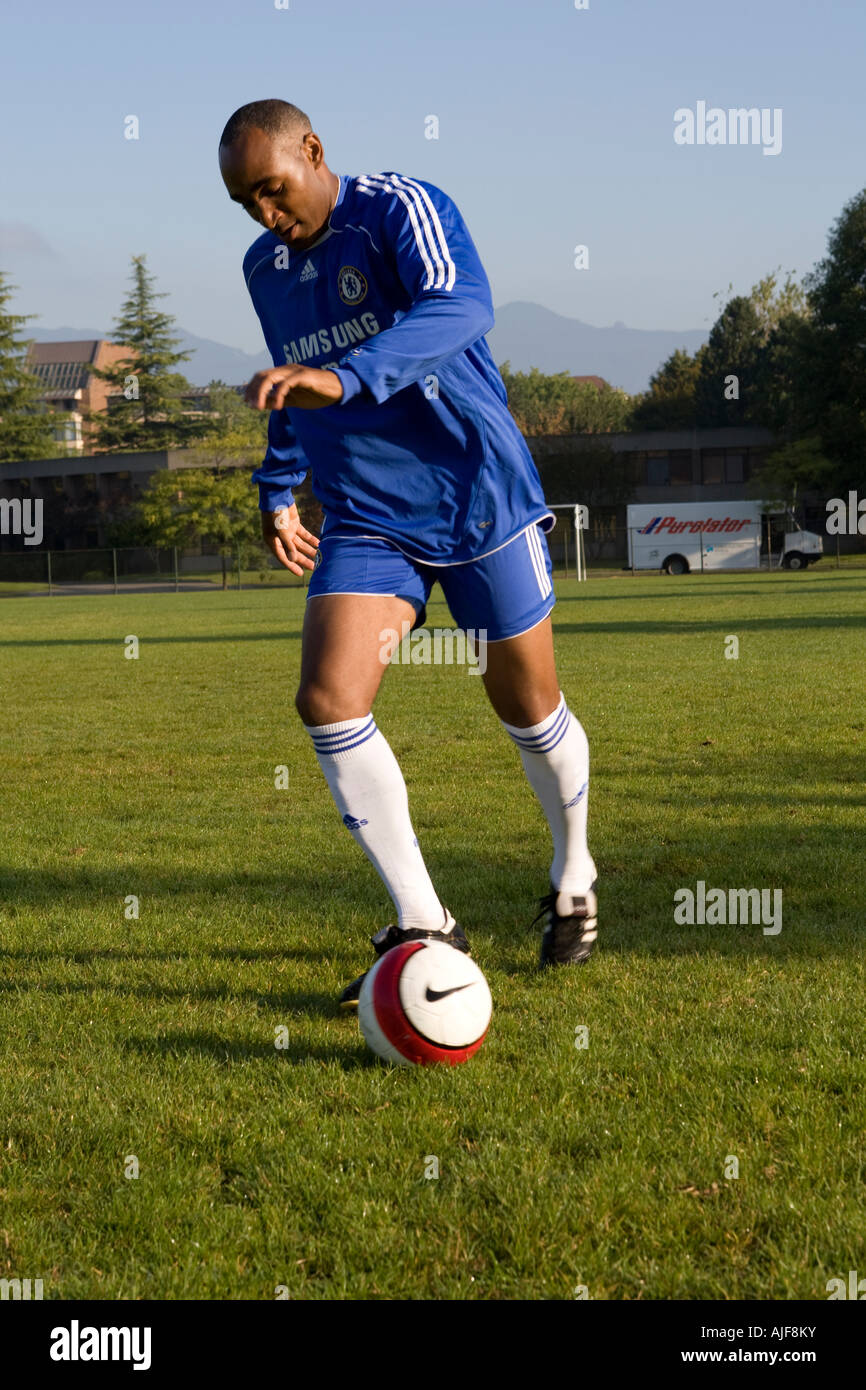 a black African American man playing soccer Stock Photo - Alamy