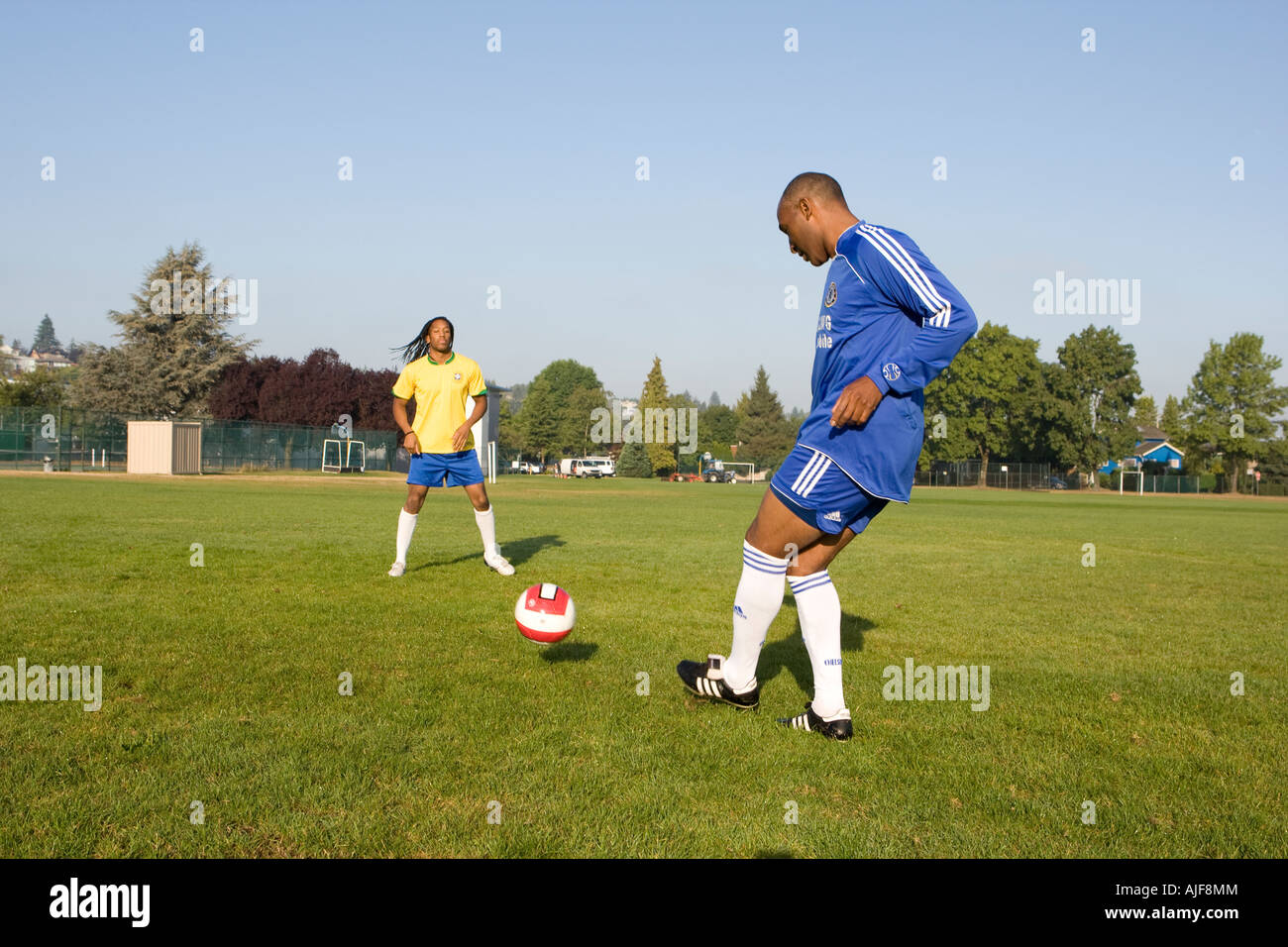 2 black African American men playing soccer Stock Photo - Alamy