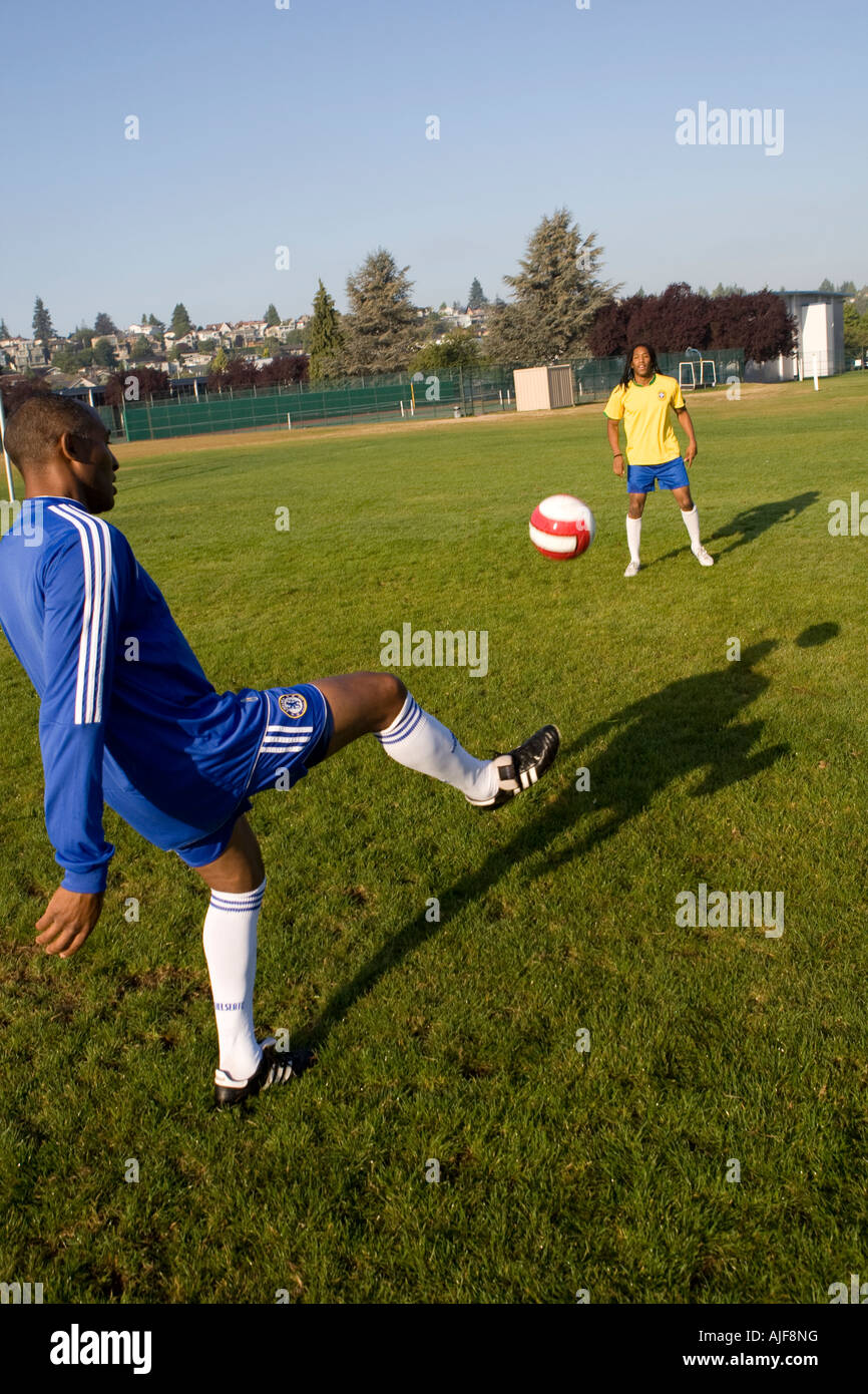2 black African American men playing soccer Stock Photo - Alamy