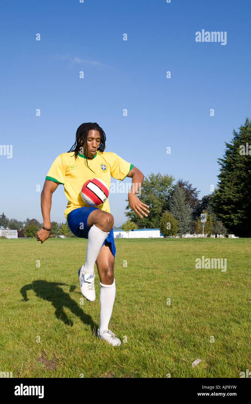 a black African American man playing soccer Stock Photo - Alamy