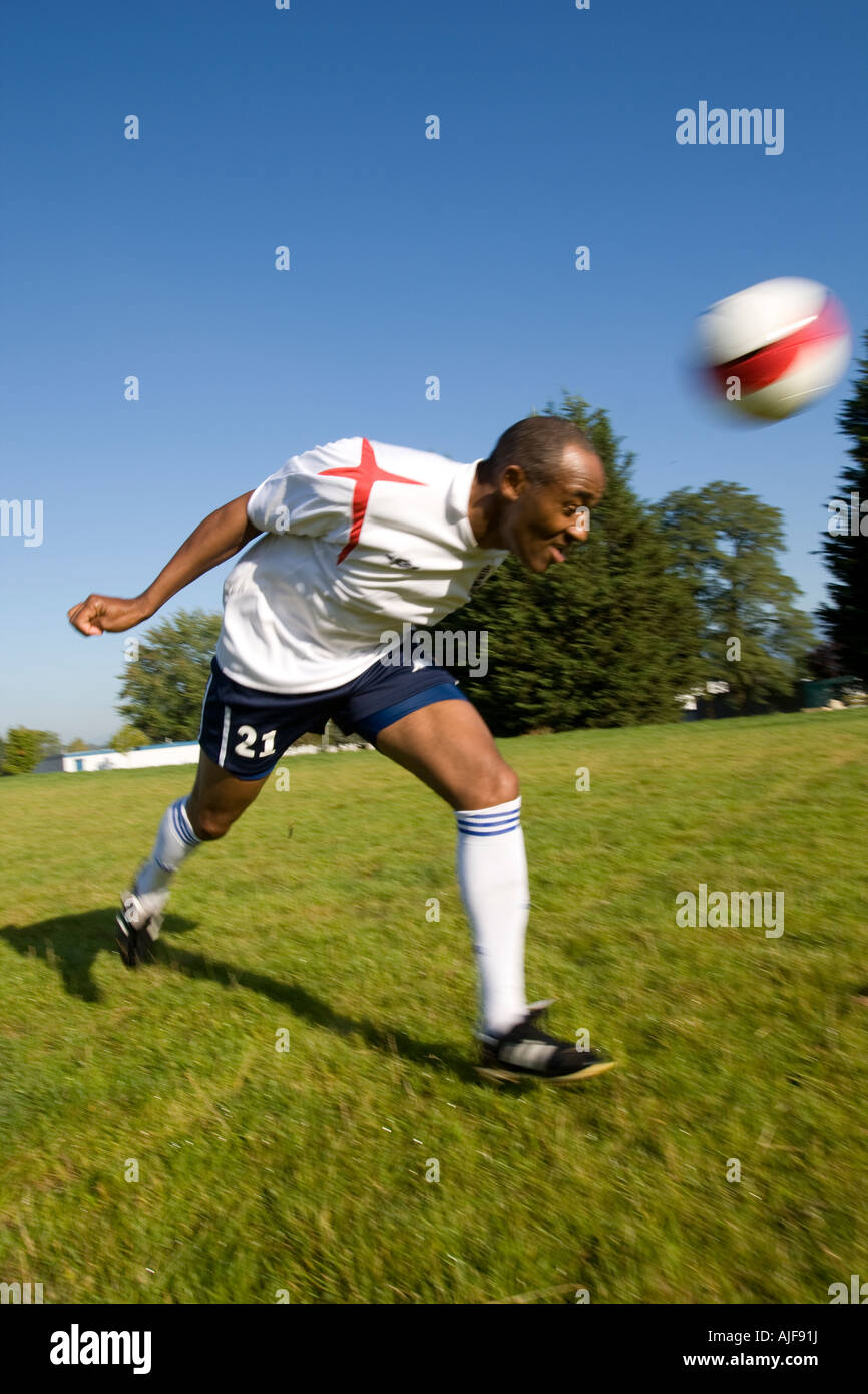 a black African American man playing soccer Stock Photo - Alamy