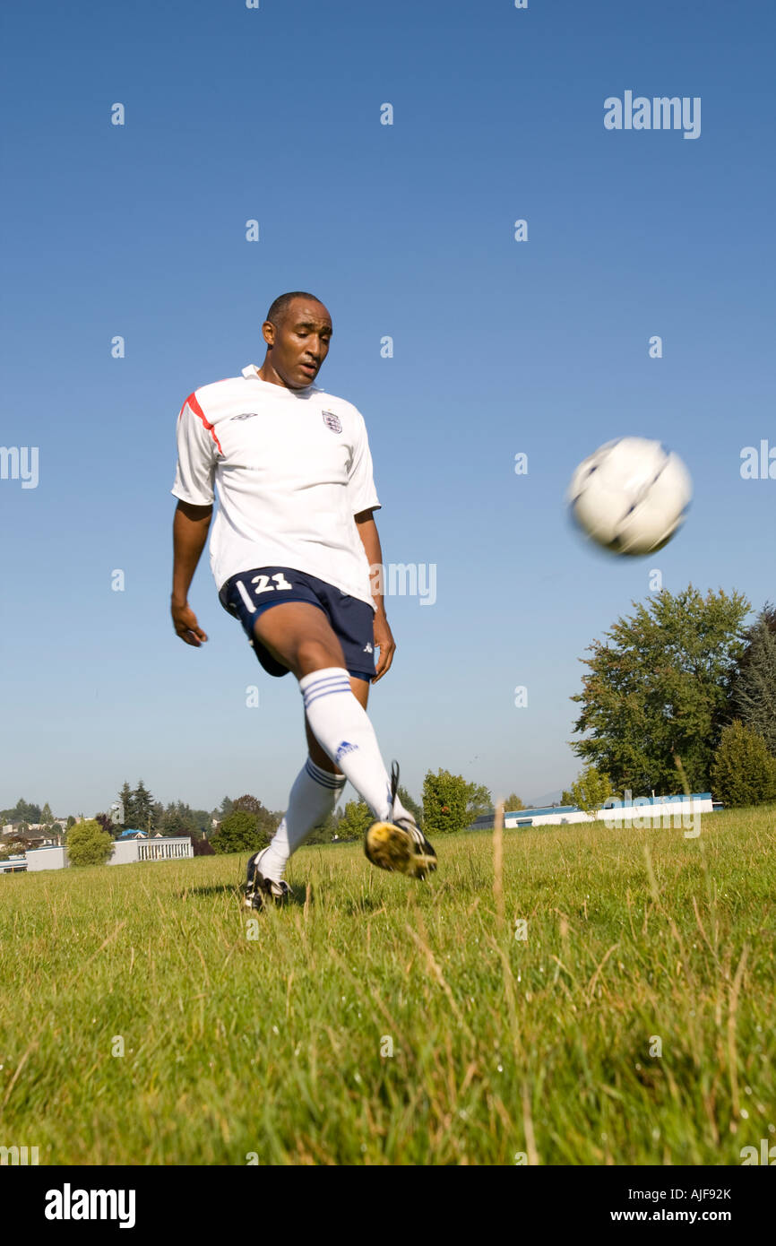 a black African American man playing soccer Stock Photo - Alamy