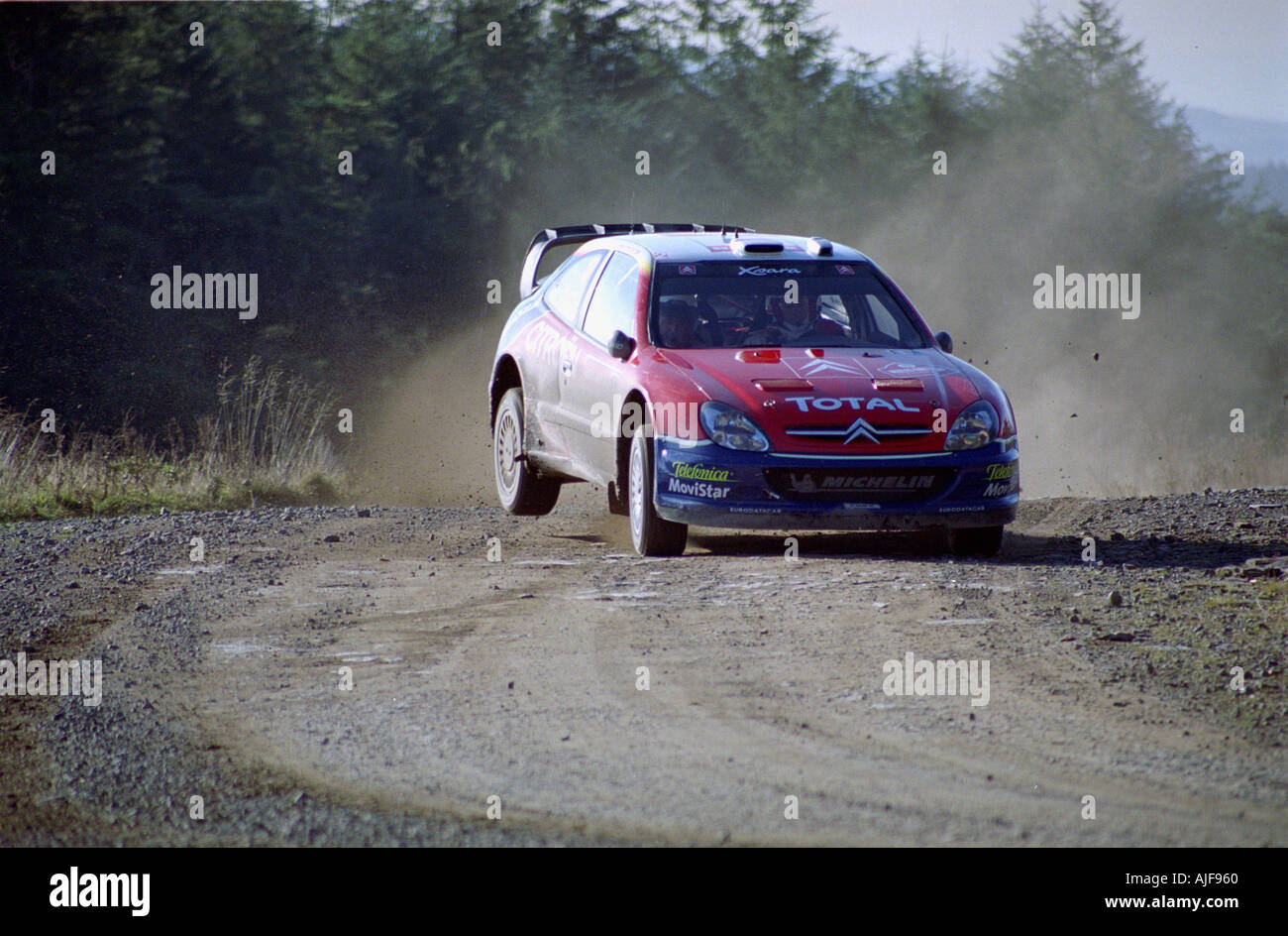 Car taking corner at speed in the Rally of Great Britain Welsh stages ...