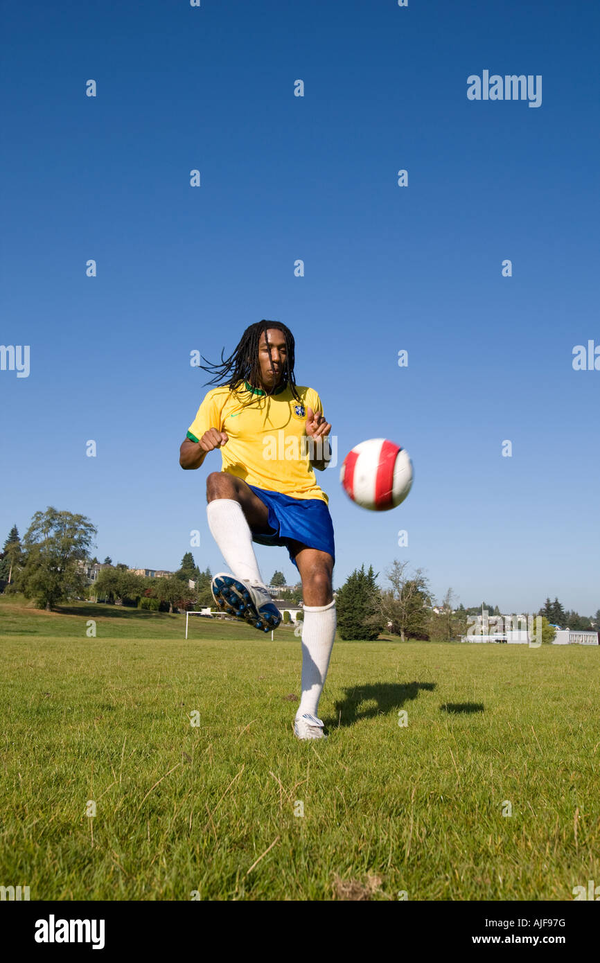 a black African American man playing soccer Stock Photo - Alamy