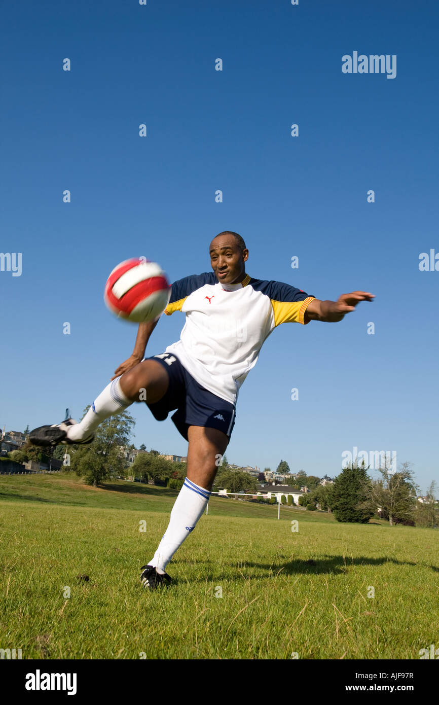 a black African American man playing soccer Stock Photo - Alamy
