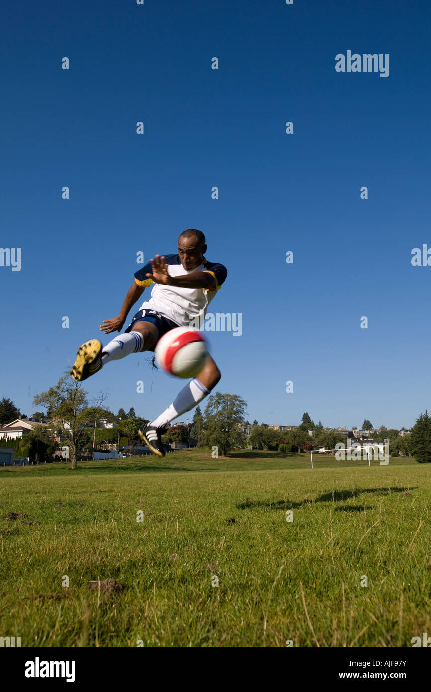 a black African American man playing soccer Stock Photo - Alamy