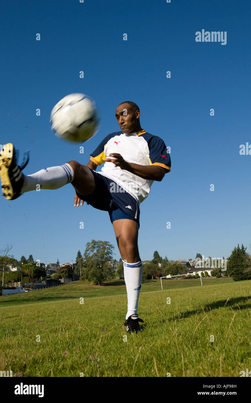a black African American man playing soccer Stock Photo - Alamy