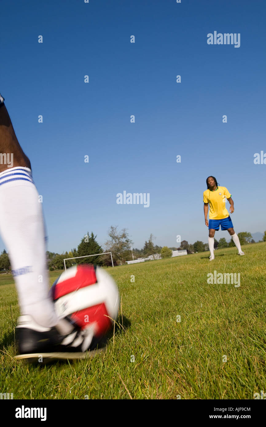 2 black African American men playing soccer Stock Photo - Alamy