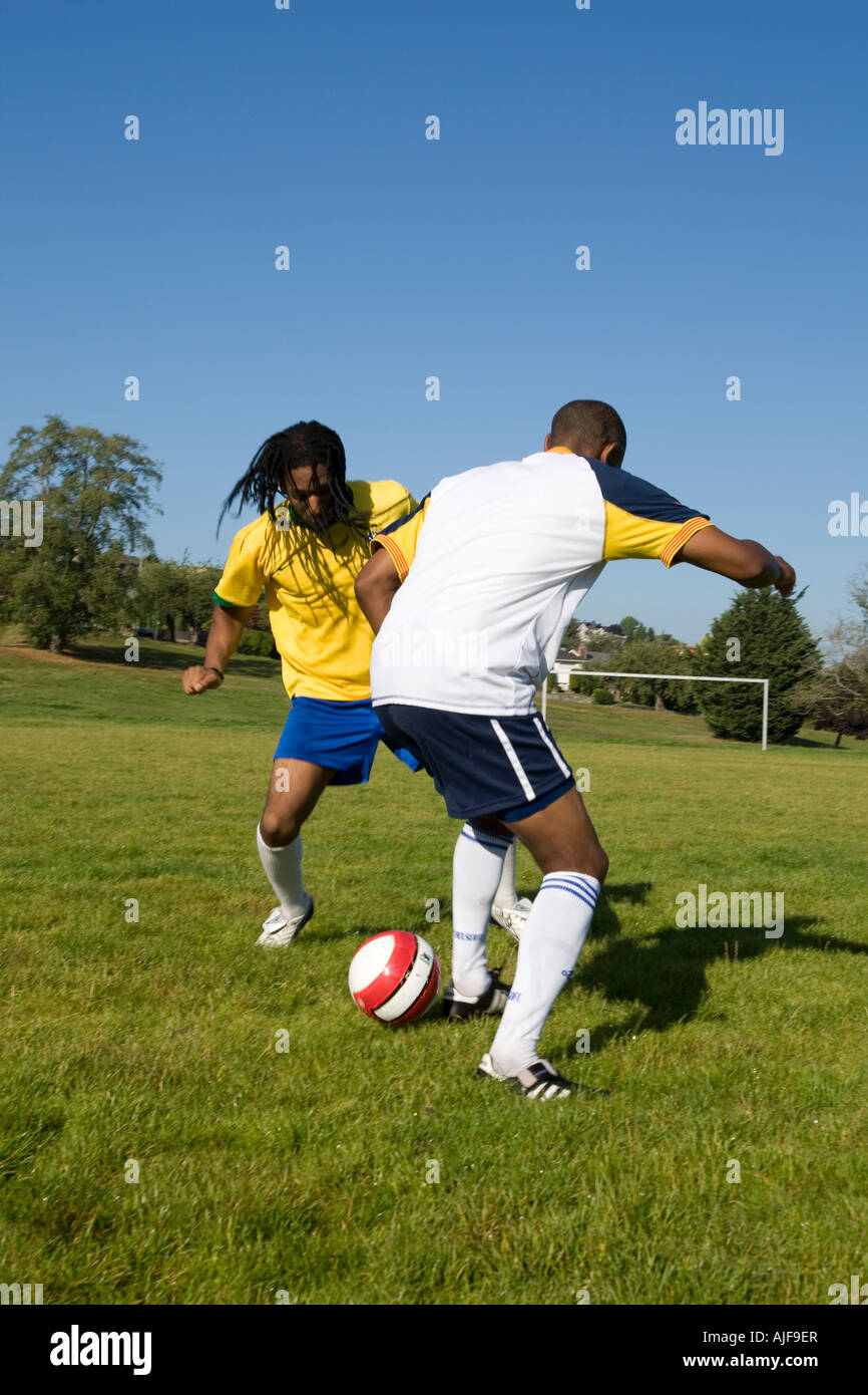 2 black African American men playing soccer Stock Photo - Alamy
