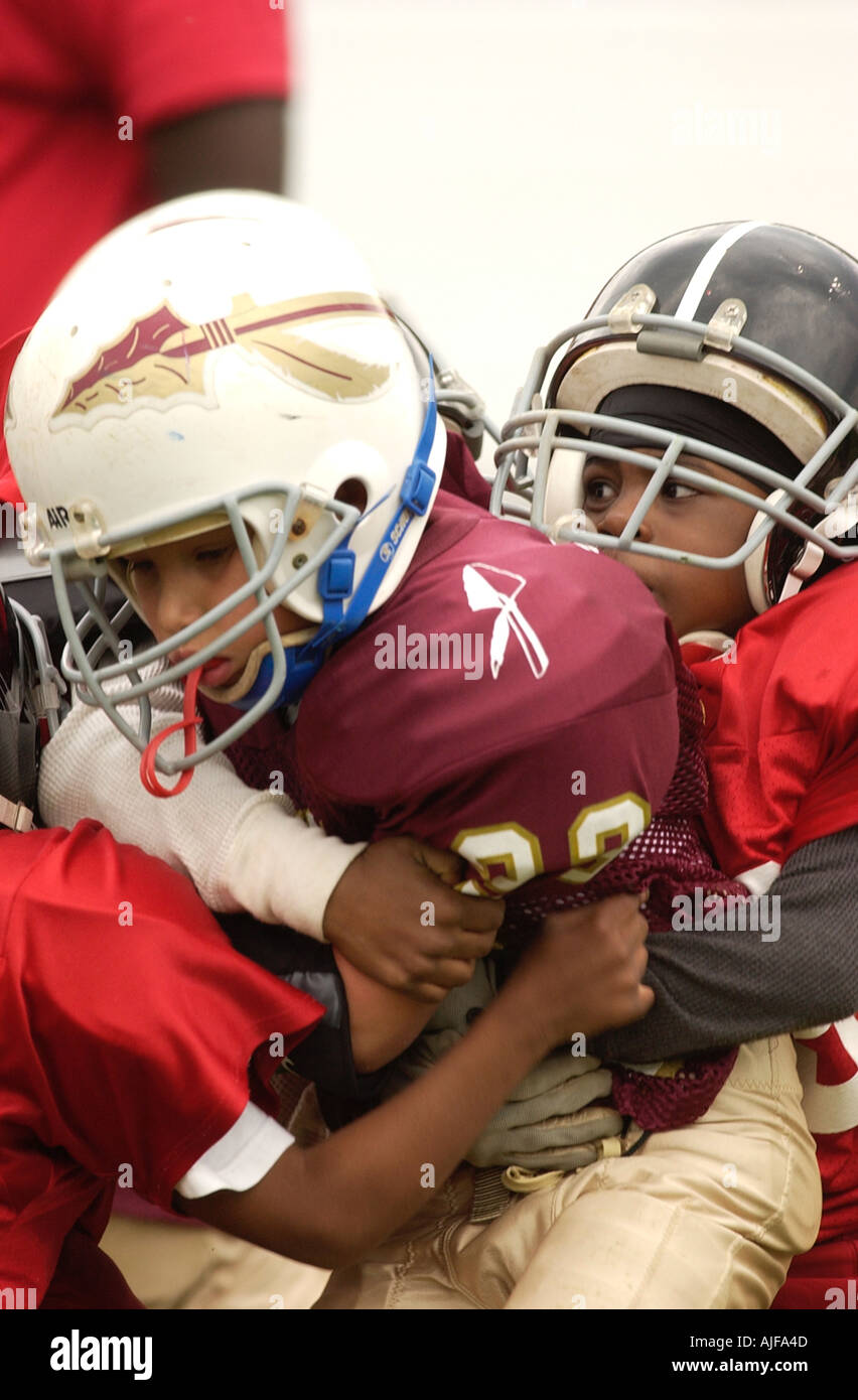 Youth biddy American football action Stock Photo - Alamy