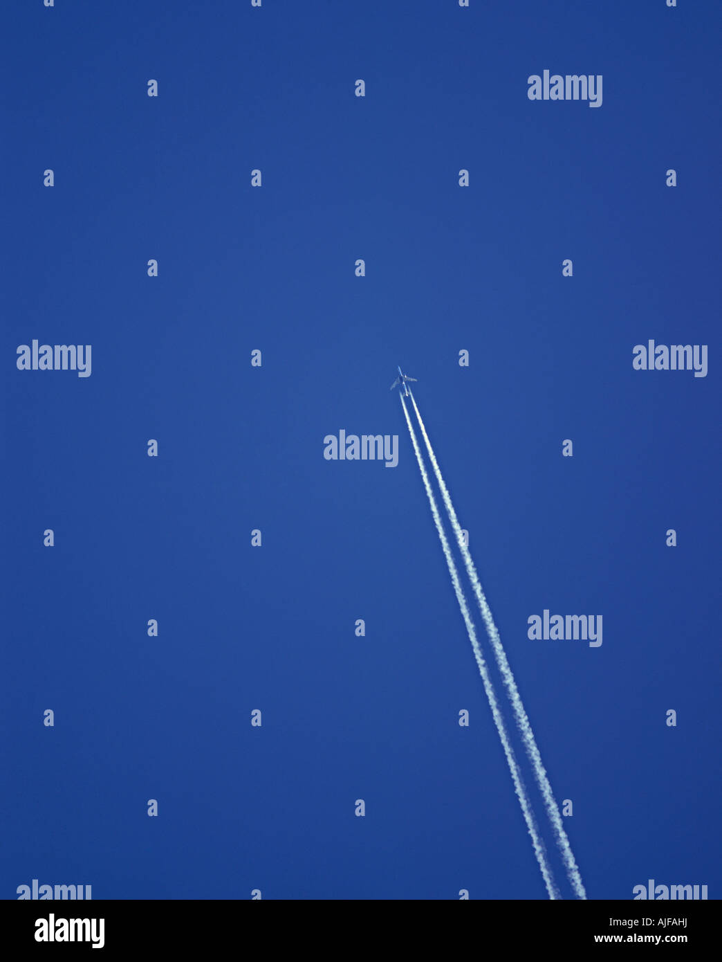 Airplane and a vapour trail Stock Photo - Alamy