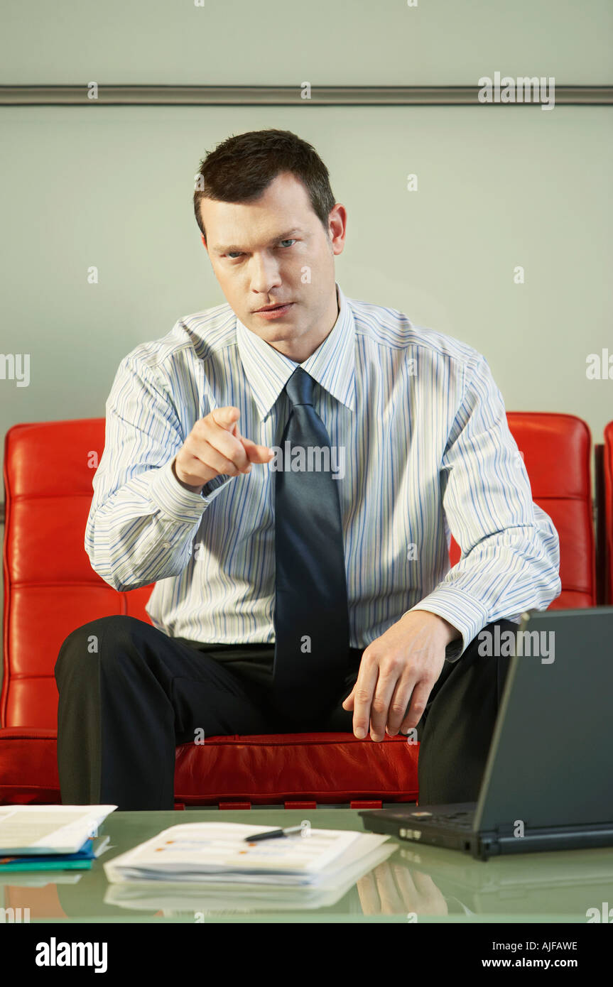 Stern Businessman Pointing, portrait, front view Stock Photo - Alamy