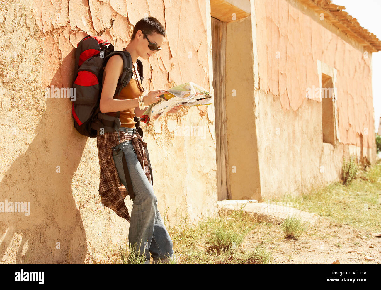 Female hiker reading map by desolate farmhouse Stock Photo - Alamy
