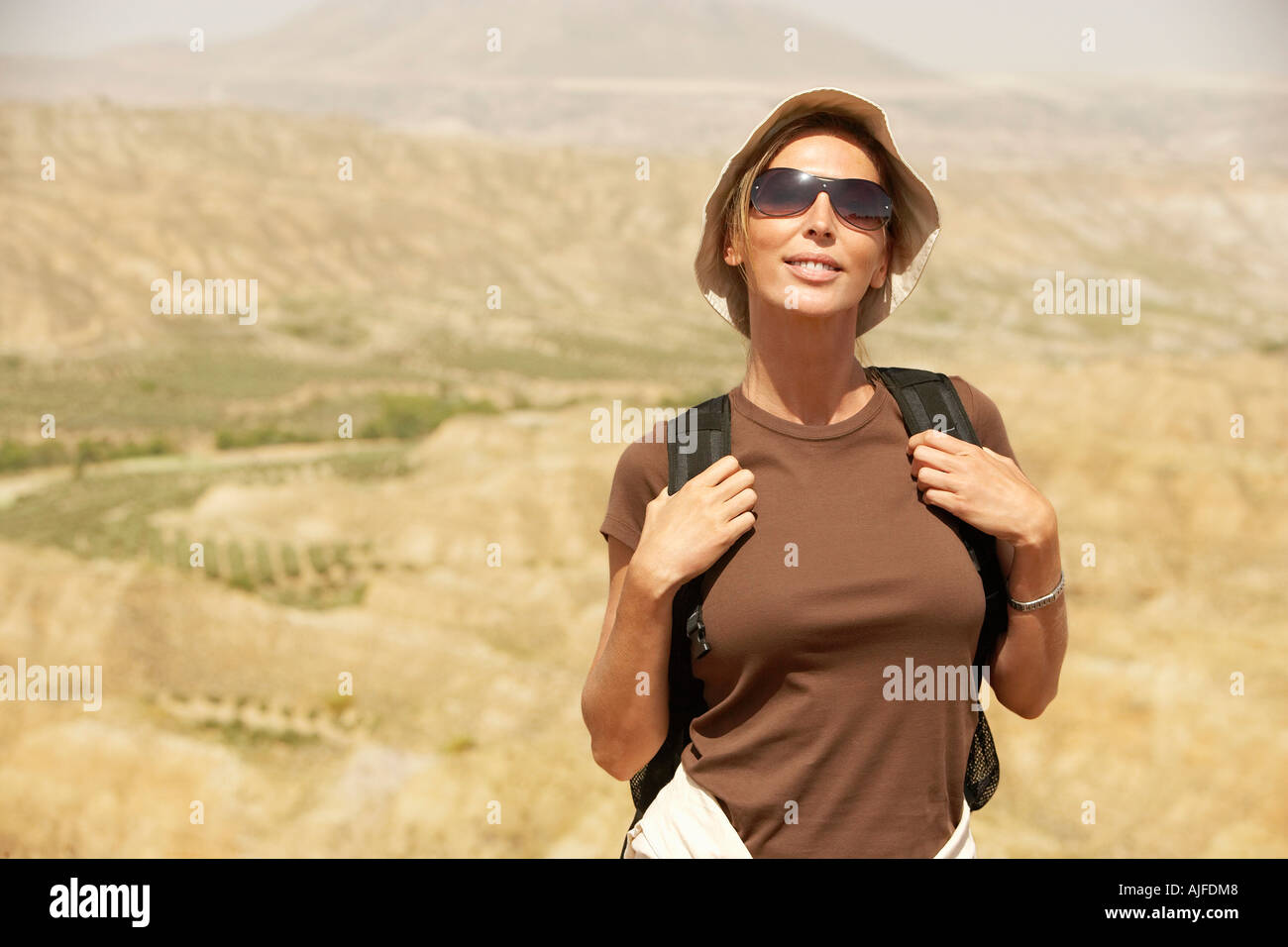 Female hiker standing on top of mountain, portrait Stock Photo - Alamy