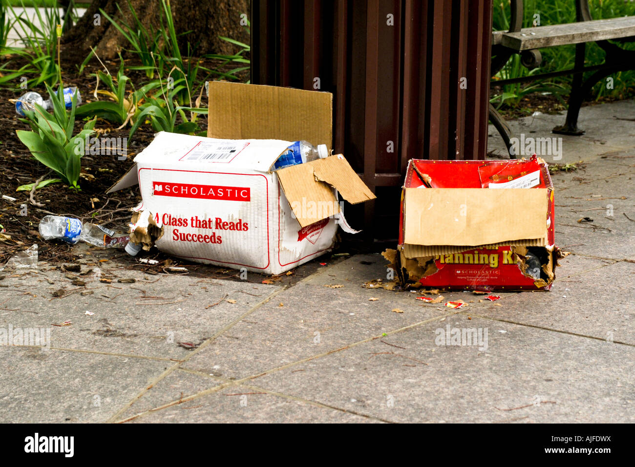 Empty plastic bottle left by the side of a trash canister Stock Photo ...