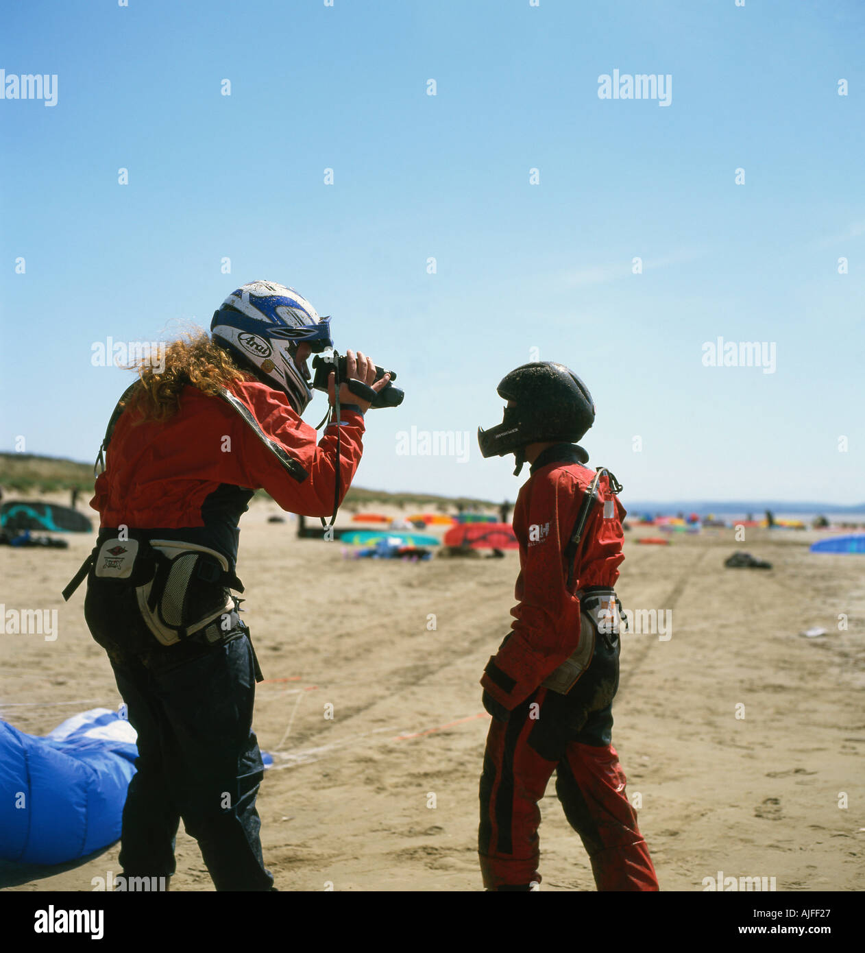 People in kite buggy gear with video camera filming at Pembrey Sands ...