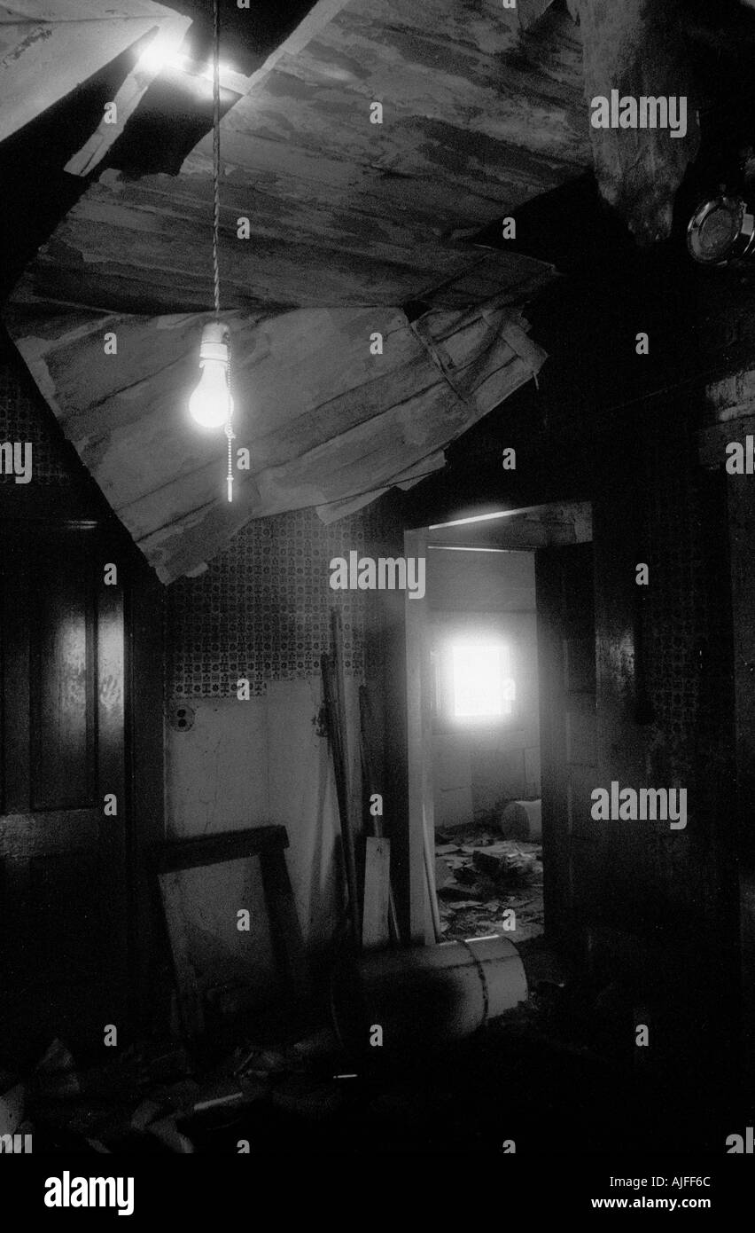Interior of a rundown old house with glowing lightbulb hanging from ...