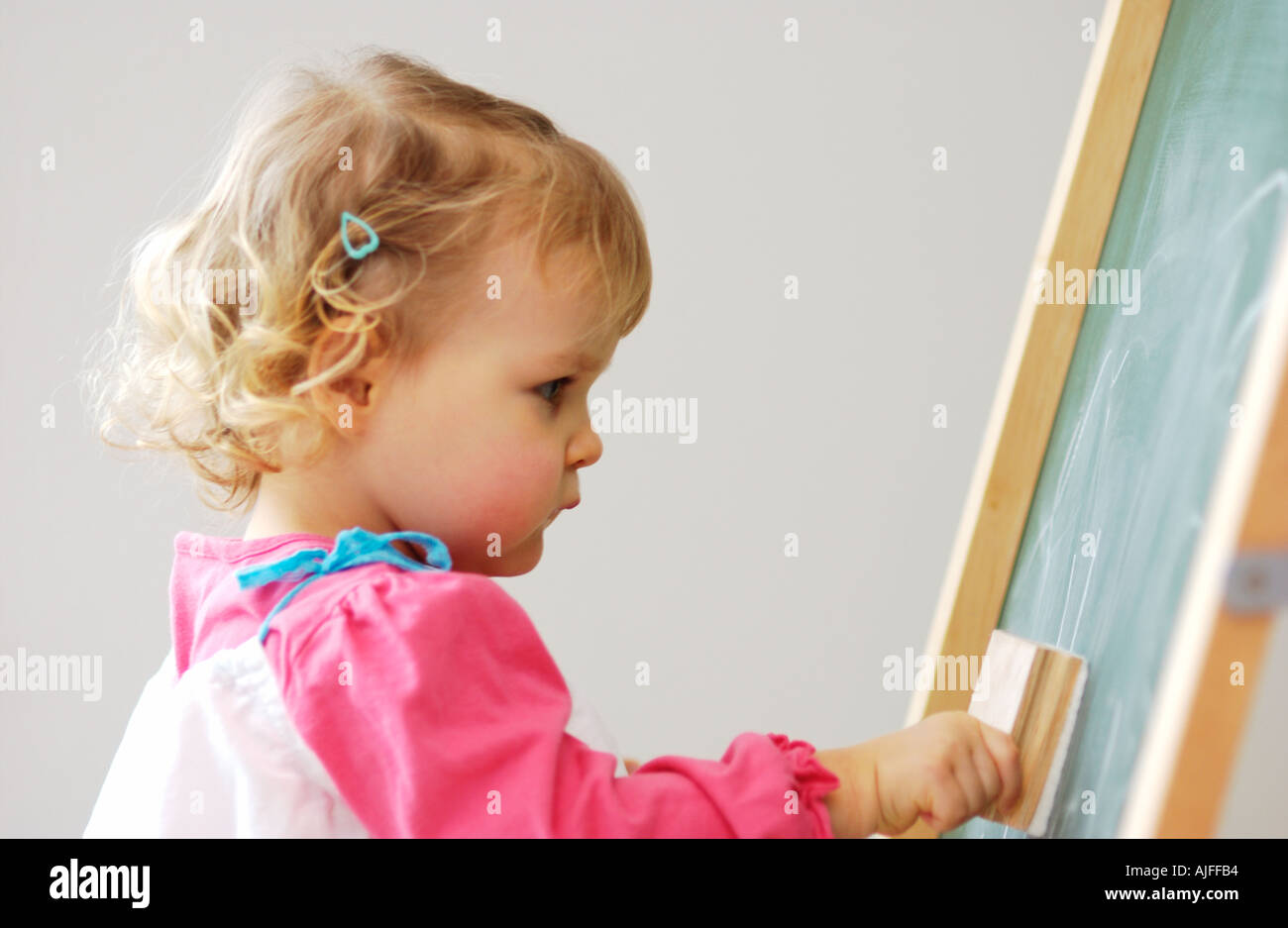 Girl erasing blackboard hi-res stock photography and images - Alamy