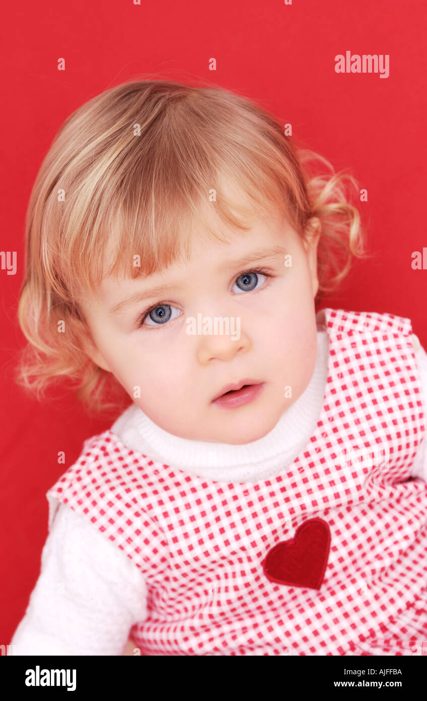 Two year old girl with heart on dress Stock Photo - Alamy
