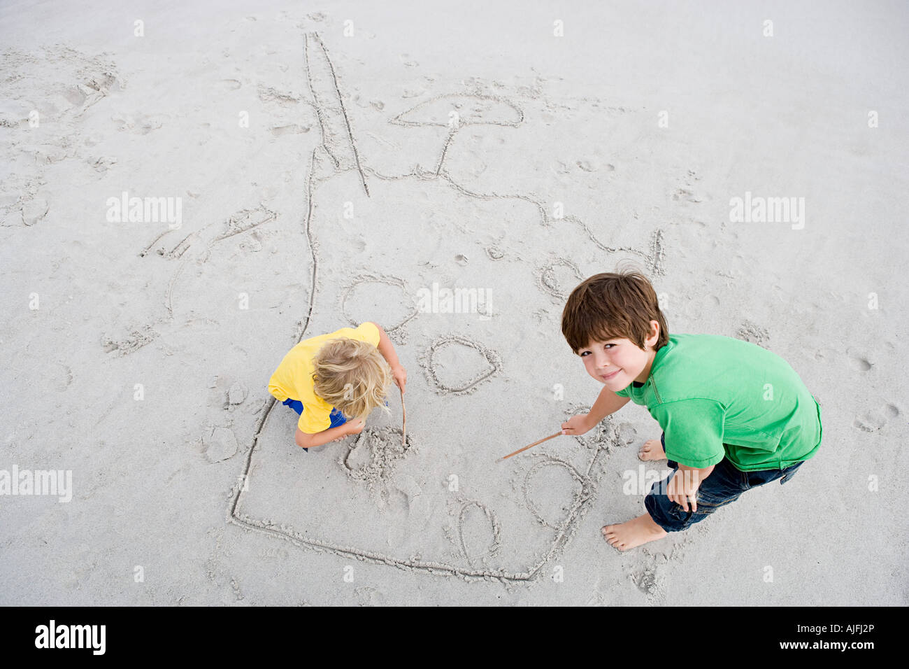 Boy Drawing In Sand Stick High Resolution Stock Photography and Images ...