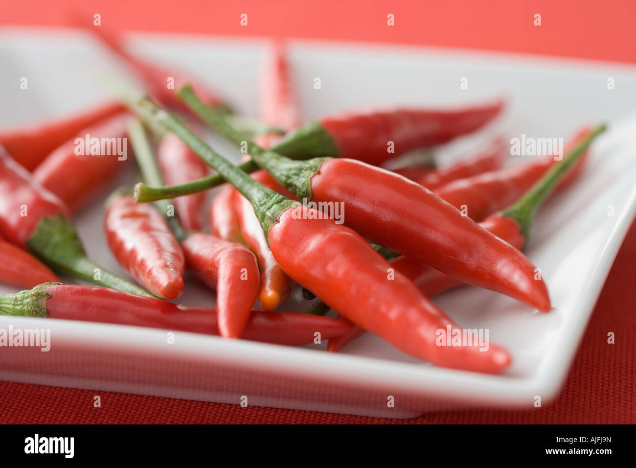 Red chilli peppers on a dish Stock Photo - Alamy