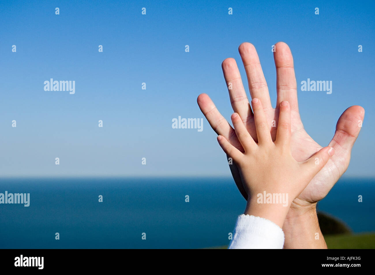 Childs hand on an adults hand Stock Photo - Alamy