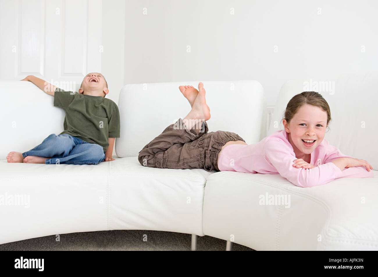 Children relaxing on sofa Stock Photo - Alamy
