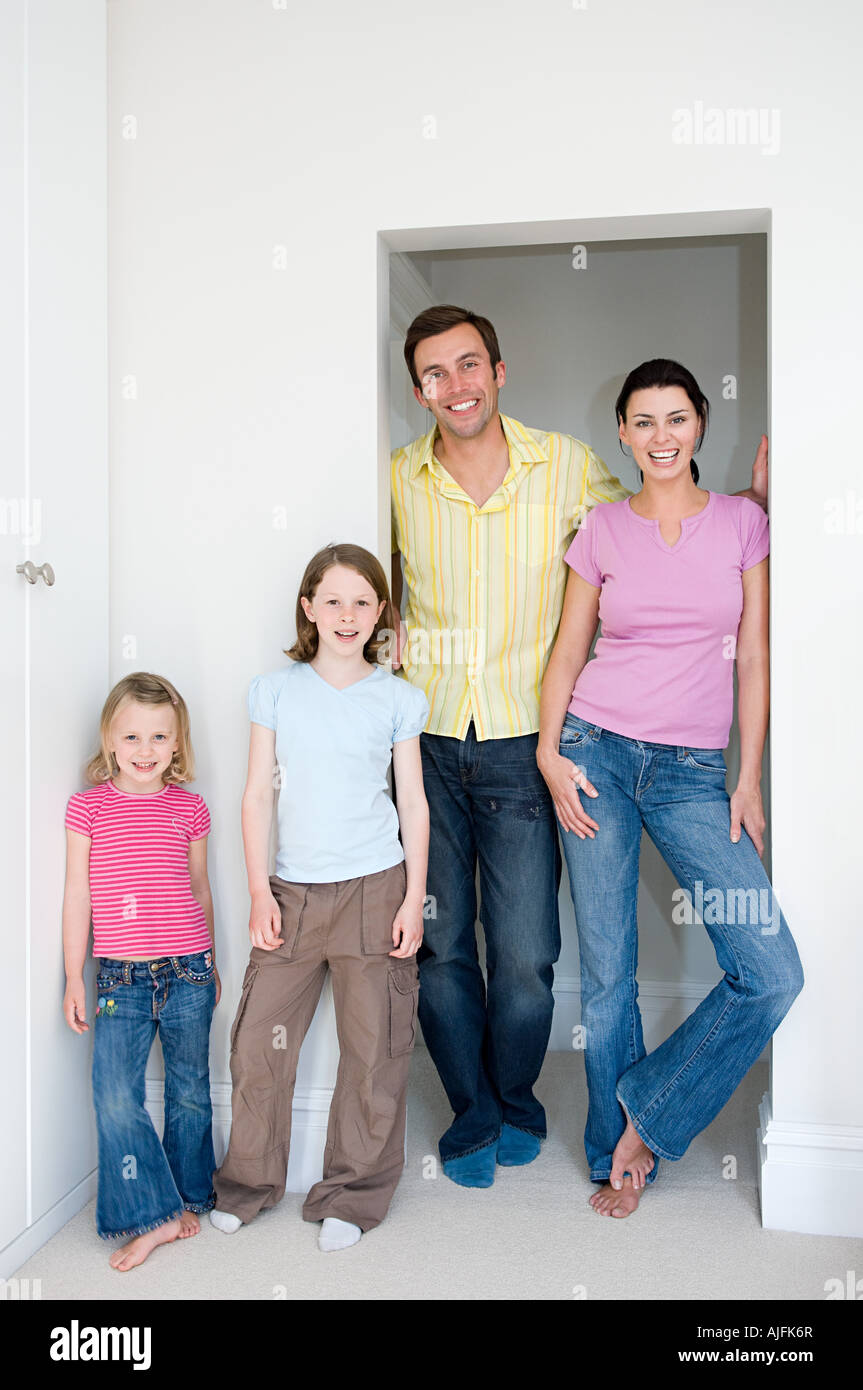 Family standing in a doorway Stock Photo - Alamy