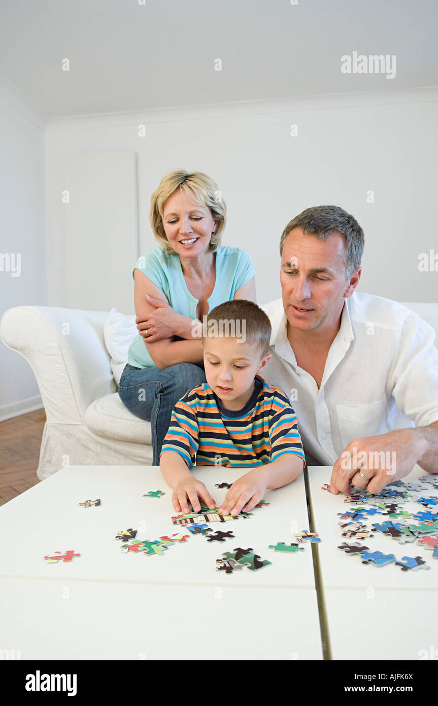 Family doing a jigsaw puzzle Stock Photo - Alamy