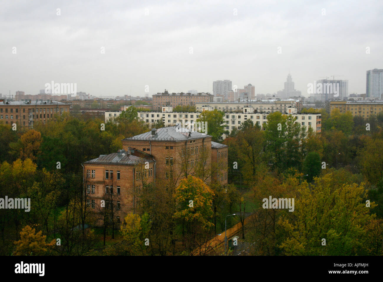 Wet rainy cloudy autumn day with typical urban buildings and colourful ...