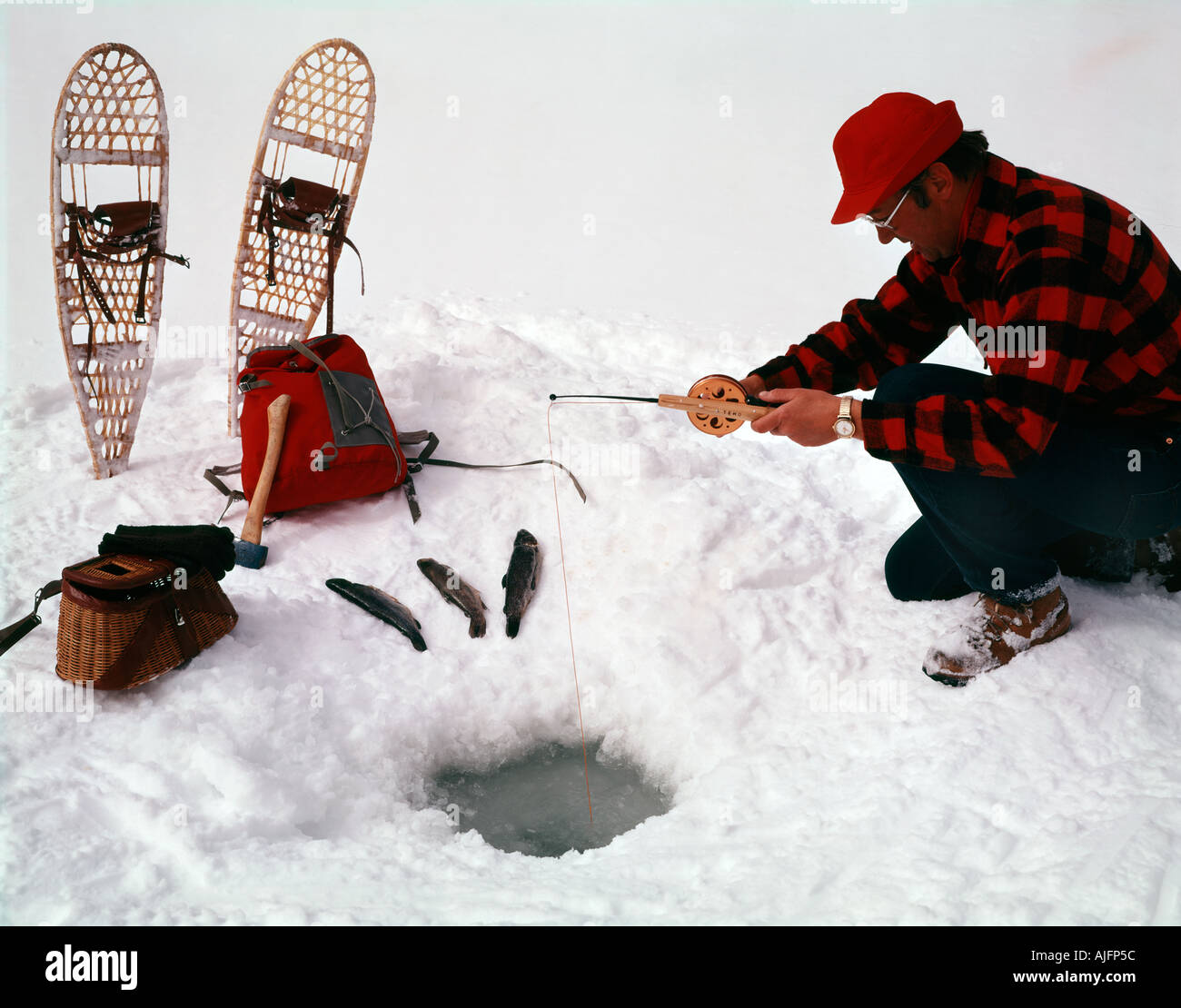 Ice fishing on a frozen lake in the Sawtooth National Recreation Area ...