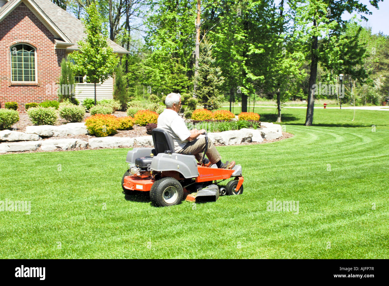Man sitting on lawn mower hi-res stock photography and images - Alamy