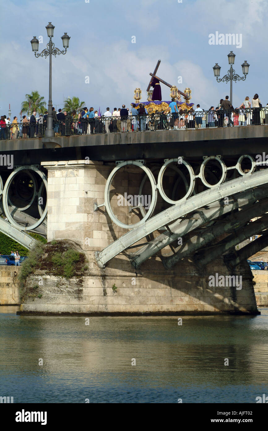 Triana bridge full of people looking at Good Friday processions Seville ...
