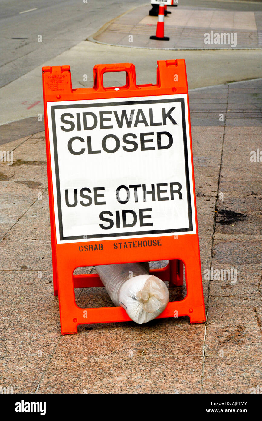 Bright orange sign Sidewalk Closed Stock Photo - Alamy