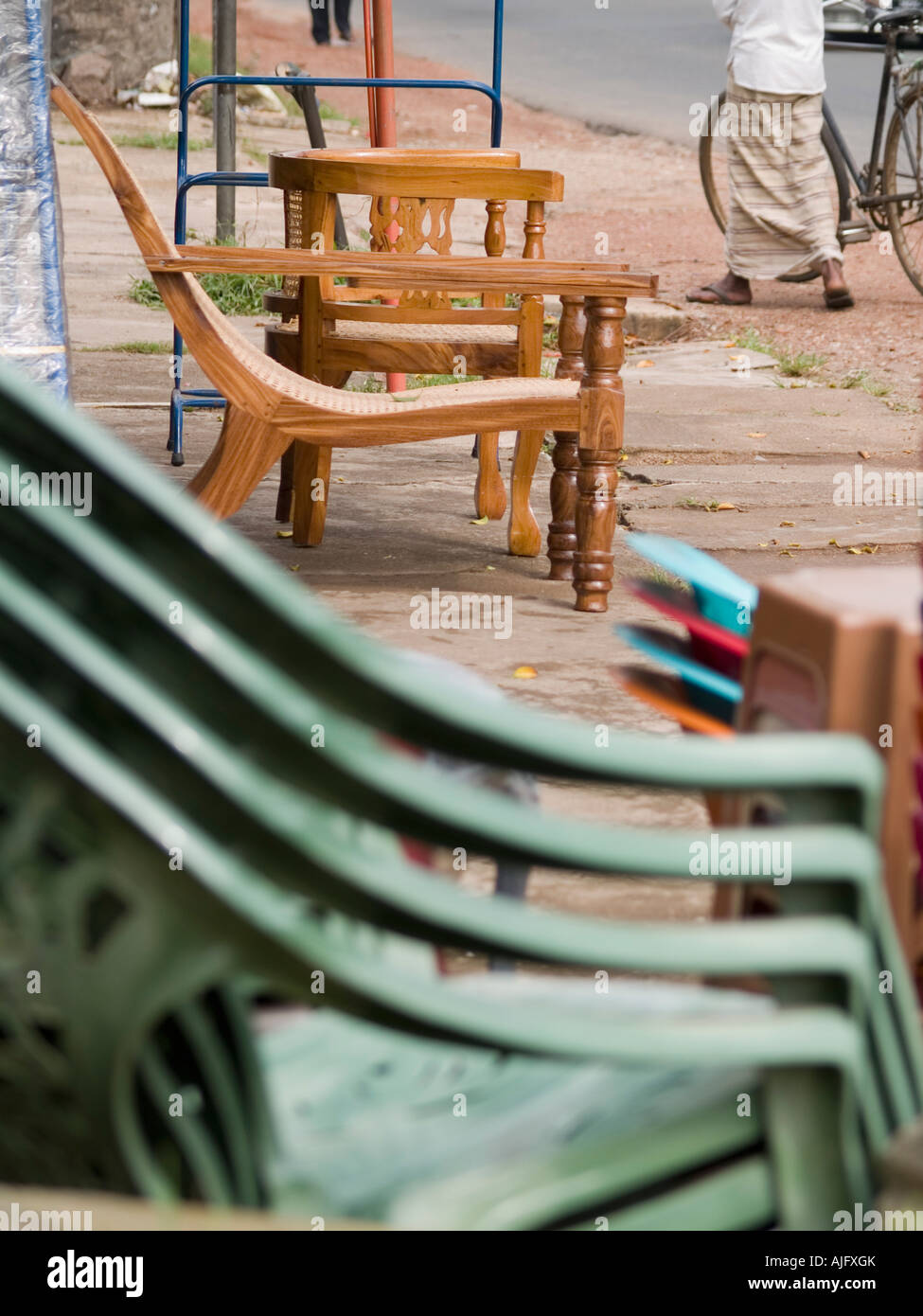 Chairs made from plastic and from local materials side by side in a ...