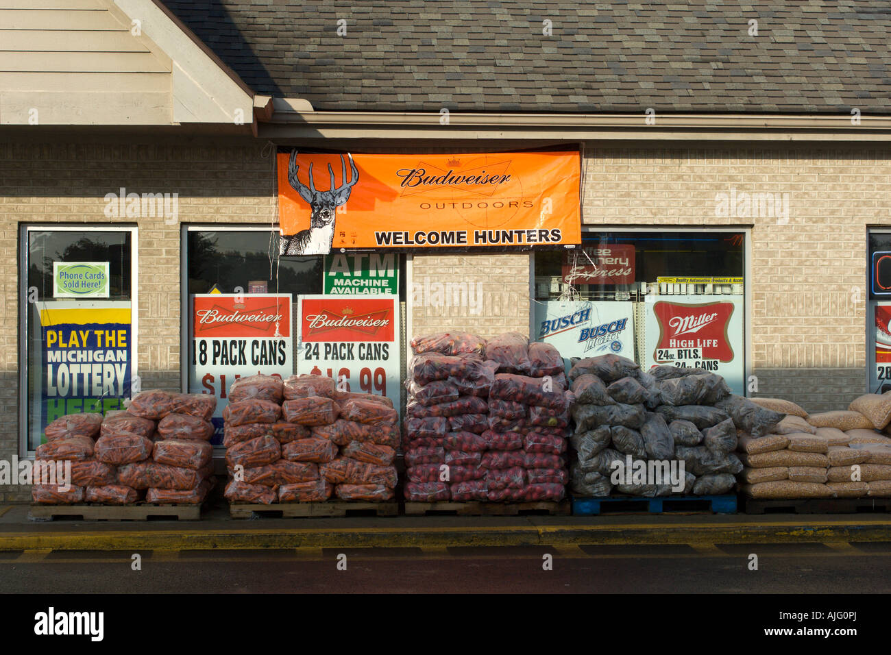 Gas station with deer feed in plastic bags and a sign saying Budweiser ...