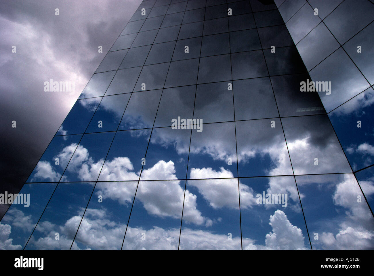 Modern contemporary Glass office tower reflecting clouds Stock Photo ...