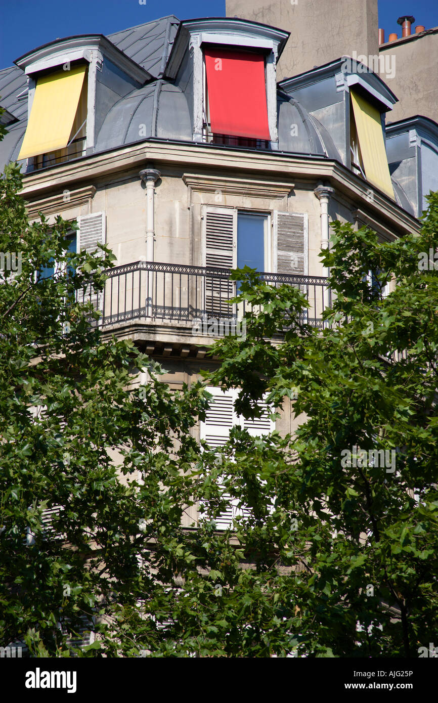 FRANCE Ile De France Paris Rooftop attic apartment windows with red and ...