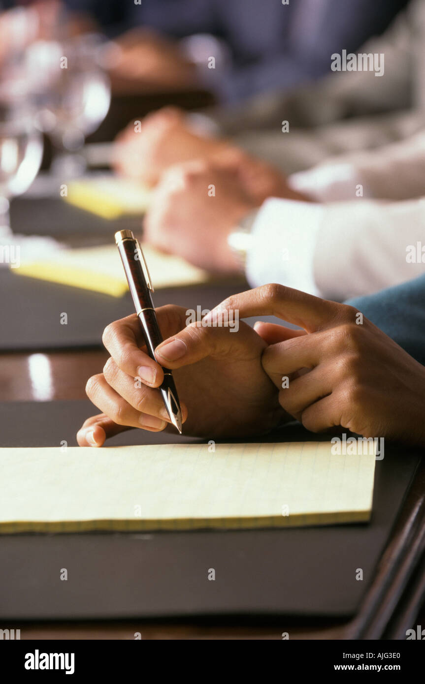 Executive hand with pen and paper during Business Meeting Stock Photo ...