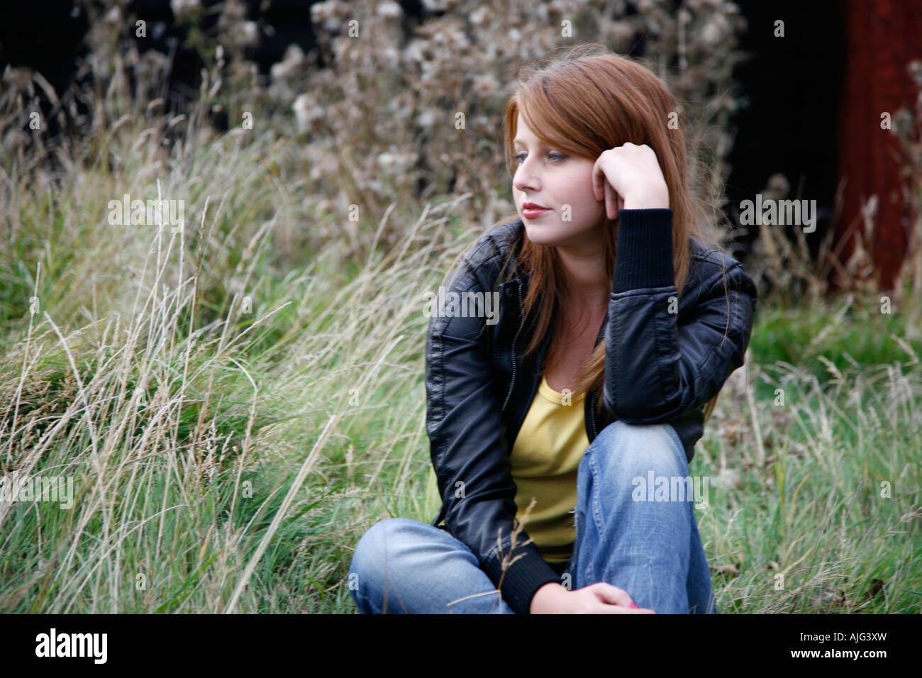 Young Girl, Sat on Grass Stock Photo - Alamy