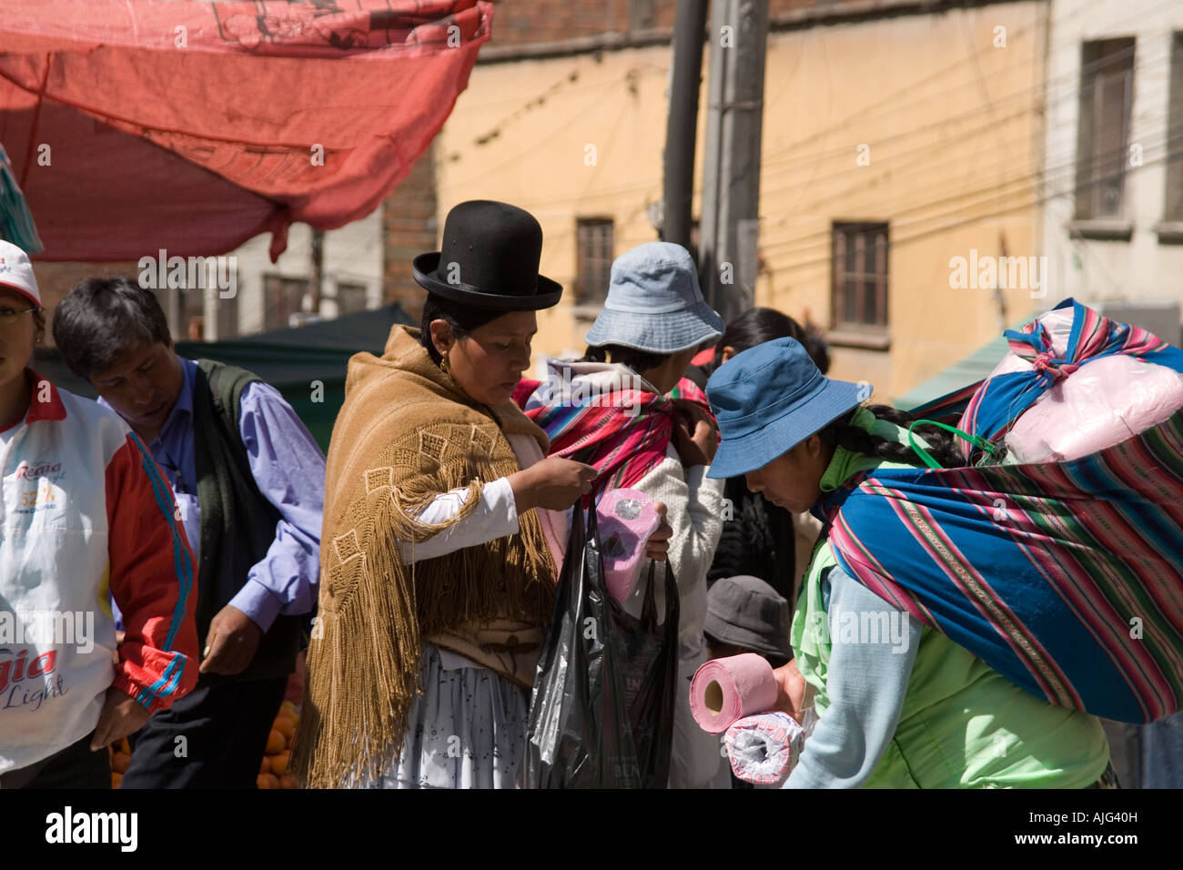 Aymara people and a food stall in the market district of La Paz ...
