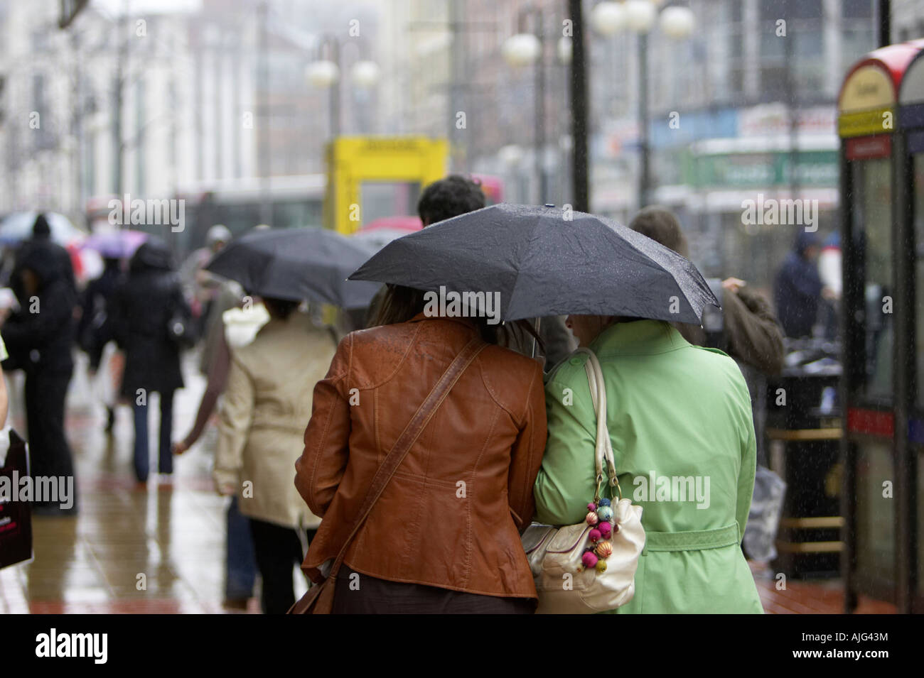 Two friends walking in rain hi-res stock photography and images - Alamy