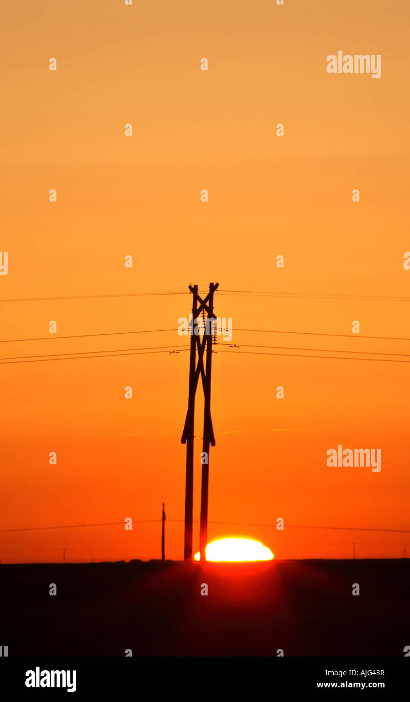Sun setting behind Saskatchewan Hydro power poles Stock Photo - Alamy