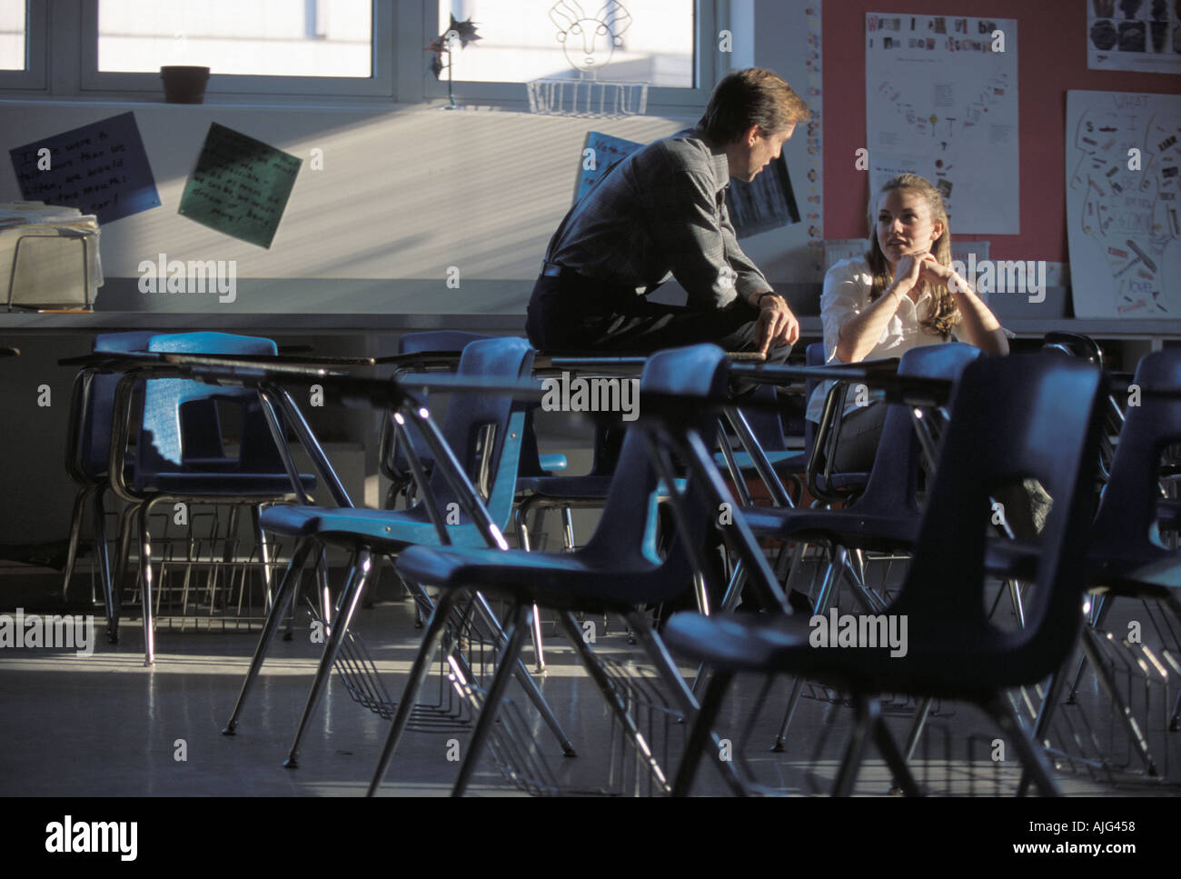 Concerned Caucasian teacher Advising female high school student after ...