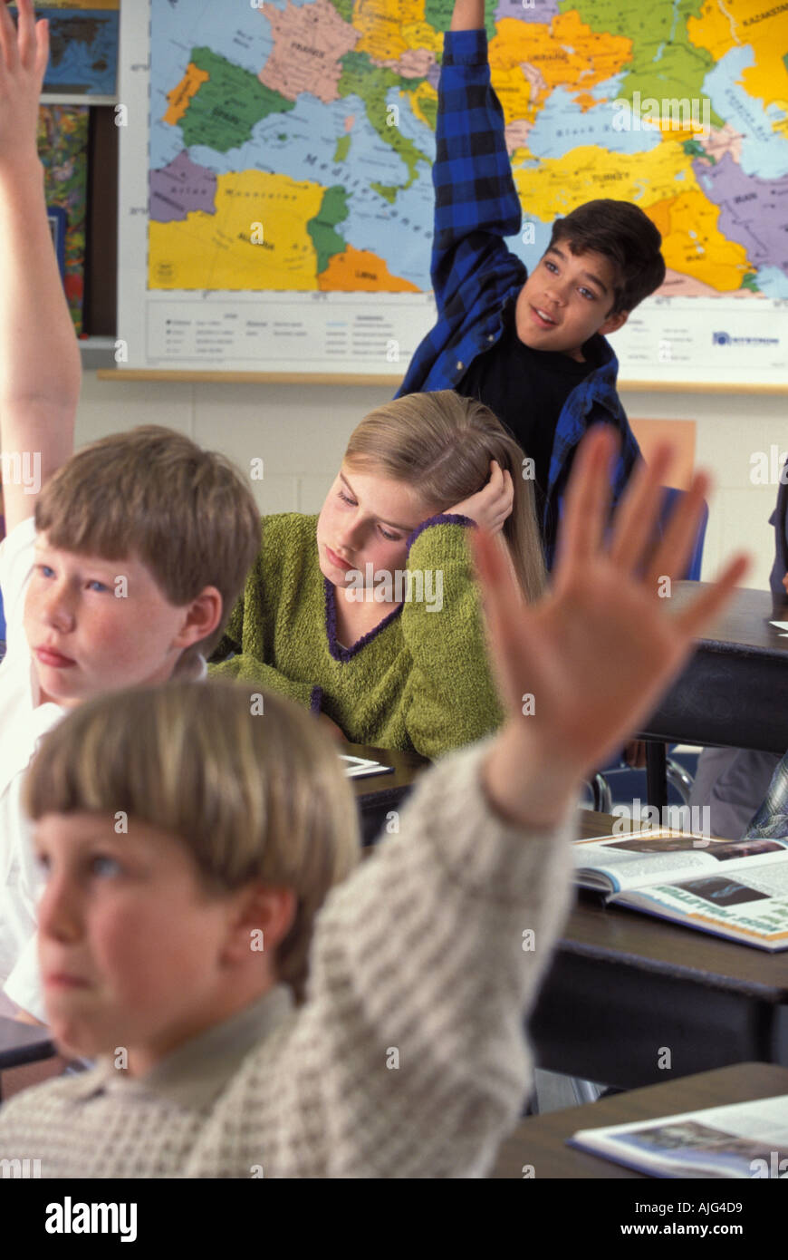 Underachieving student sitting a mixed group of enthusiastic classmates ...