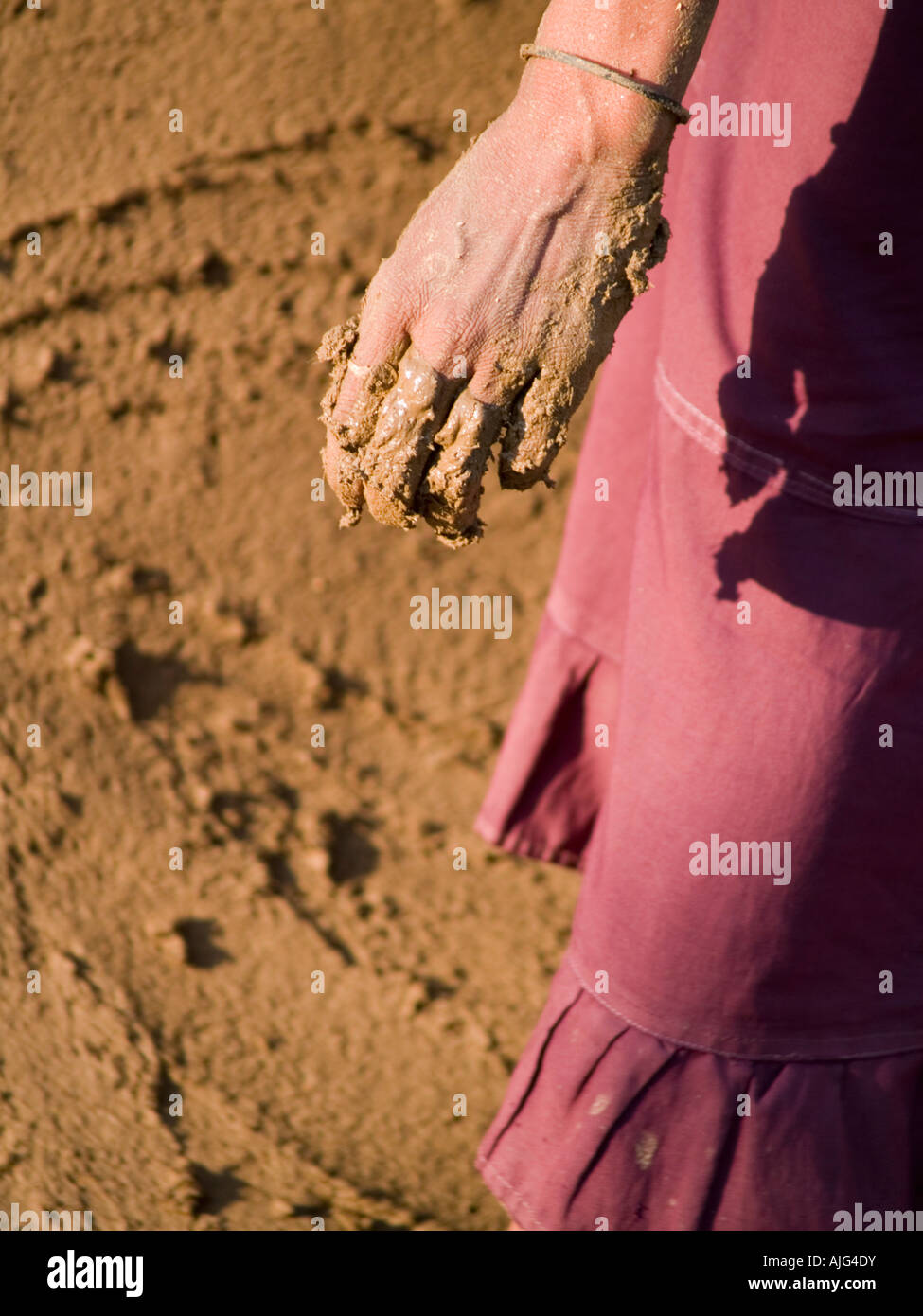 Womans hand covered in mud Stock Photo - Alamy