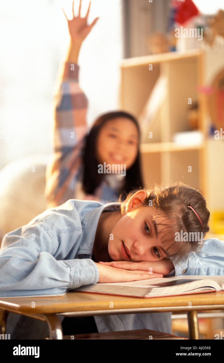 Asian American female student raising hand while Underachieving ...