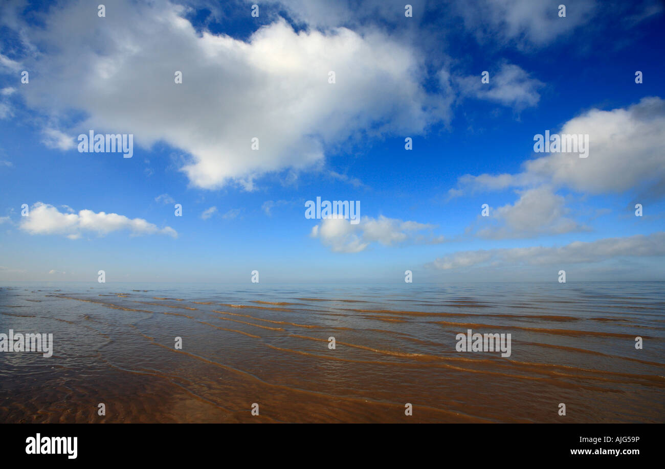 Very calm sea, blue sky with white clouds on the Norfolk coast Stock ...