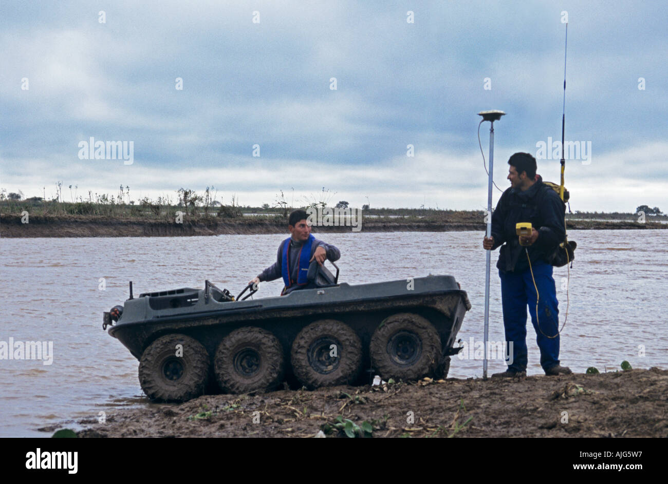 Surveyors using using GSM equipment and an amphibious terrain vehicle ...