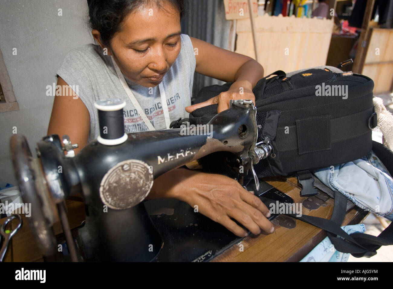 Seamstress with treadle machine sews budget traveller backpack Ko Phi ...